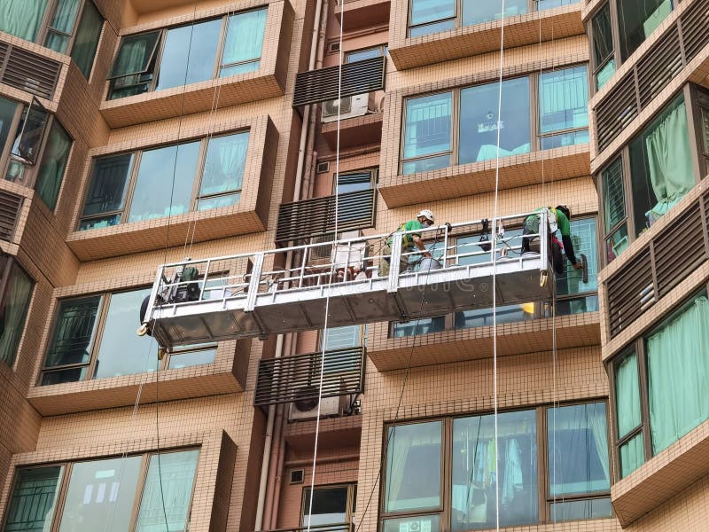 Two Professional Workers Use a Suspended Cradle or Steeplejack To ...