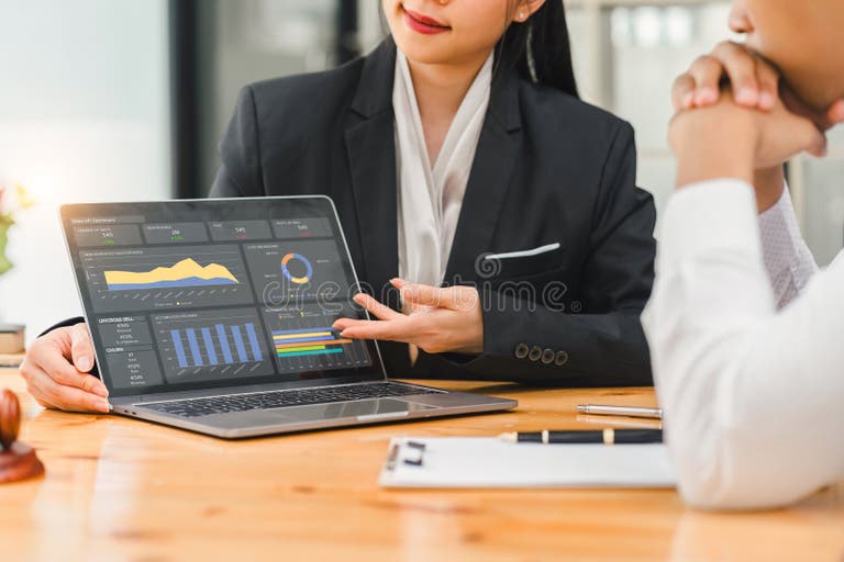 Two Professionals Analyzing Business Data on Dashboard Screen and ...