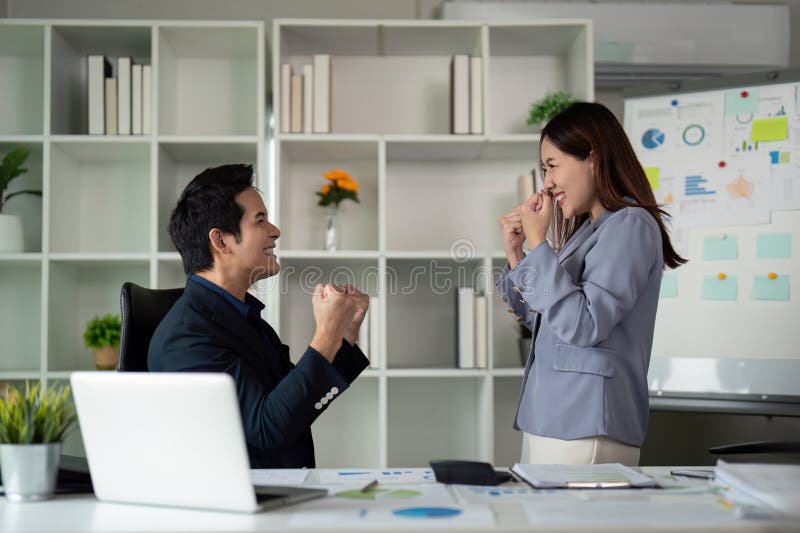 Success and Celebration. Colleagues Sharing a Moment of Victory while ...