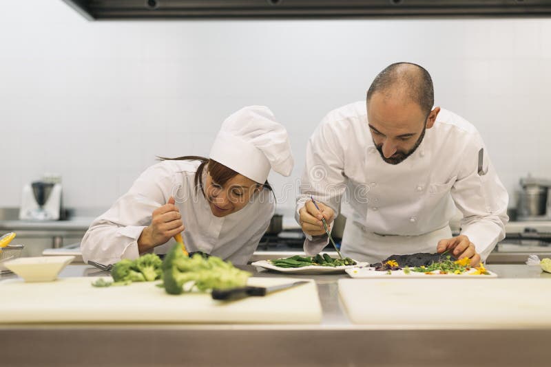 Two Professionals Chefs Cooking Together. Stock Image - Image of ...