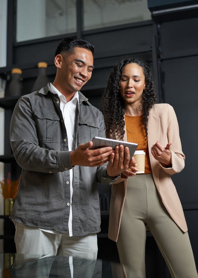 Two Professionals Collaborating in a Modern Office Environment while ...