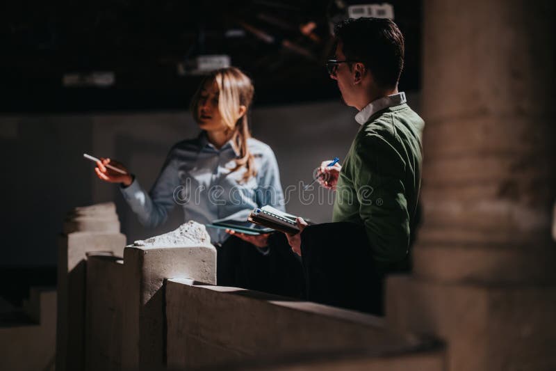 Two Professionals Discussing and Analyzing Artifacts in a Historical ...