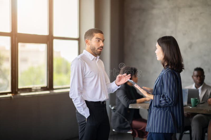 Diverse Team Members Collaborating in a Modern Office Space during a ...