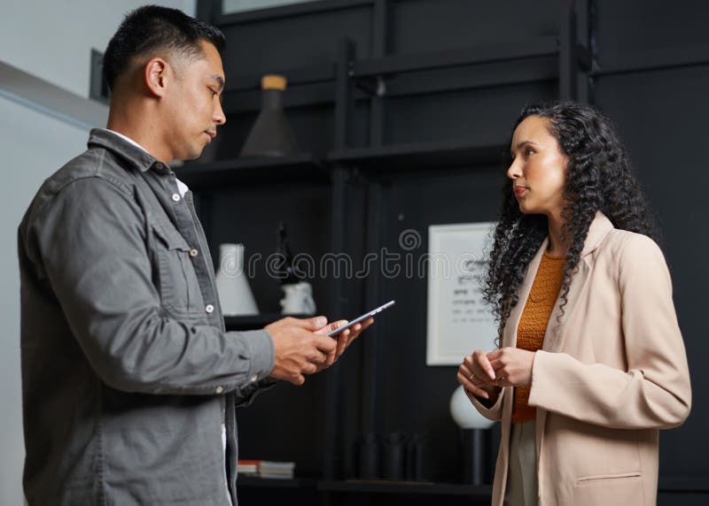 Two Professionals Engaged in Conversation about Business in an Office ...