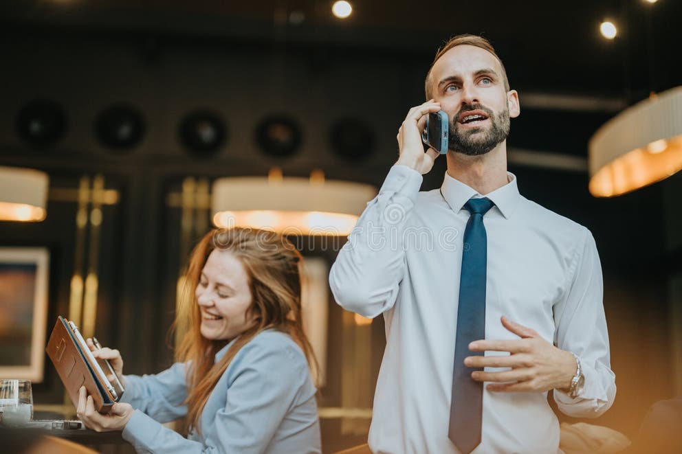 Two Professionals in a Modern Office Setting Collaborating and ...