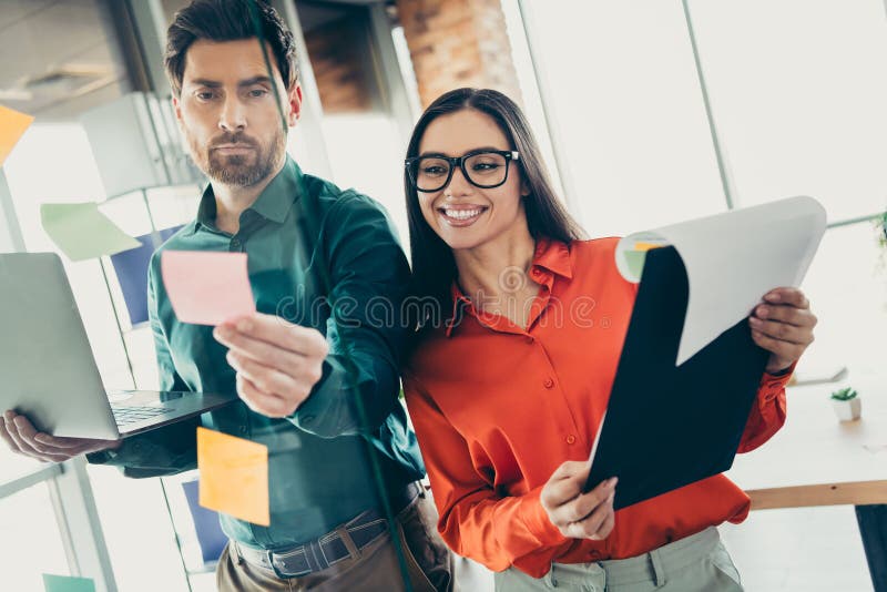 Two Professional Colleagues Discussing Plans in a Modern Workspace ...