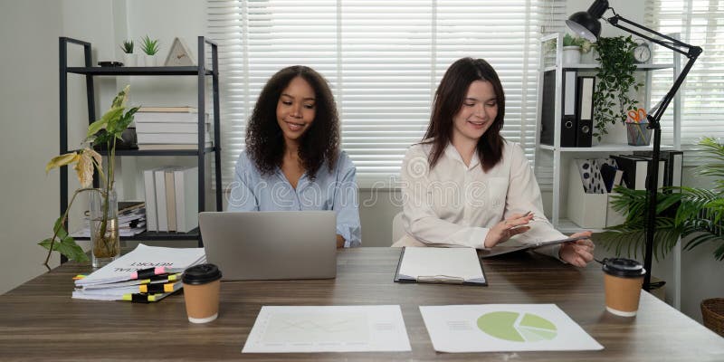 Collaboration and Creativity. Colleagues Reviewing Documents and ...