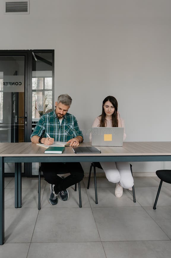Two Professionals Working Together at a Conference Table in an Office Space Stock Image - Image ...