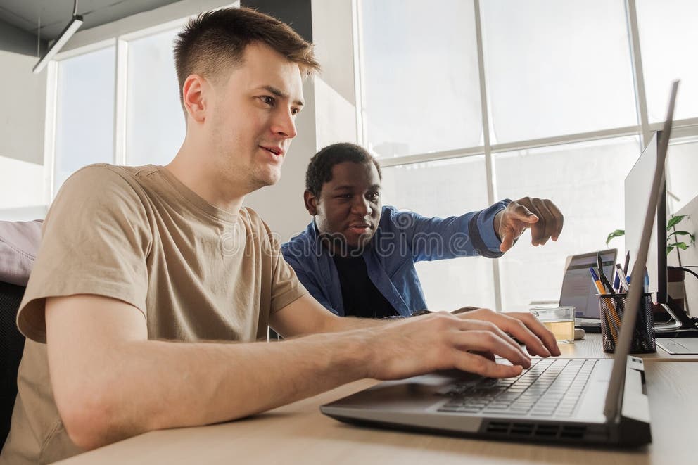 Two Programmers Working in the Office of a Software Development Company ...