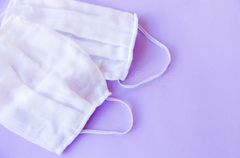 Two Protective Masks of White Color on a Purple Background. View from ...