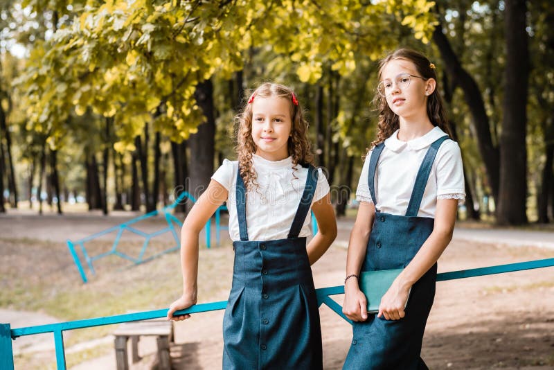 Two Pupils in School Uniform Enjoy a Walk in the Park on a Warm Day ...