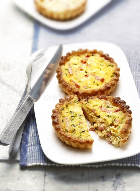 Two Quiches with Bacon on a Plate One Cut in Half Stock Photo - Image ...