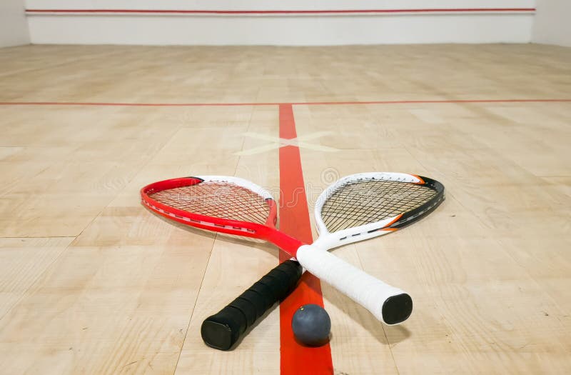 Two Rackets and Two Squash Balls Lie on the Parquet Floor. Stock Image ...