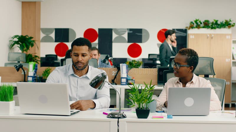 Two Ravishingly Attractive African Workers are in a Large Brightly Lit ...