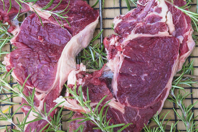 Two Raw Beef Steaks with Herb on Grid Stock Image - Image of roasted ...