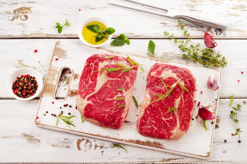 Two Raw Beef Steaks on a Wooden Board. Stock Photo - Image of food ...