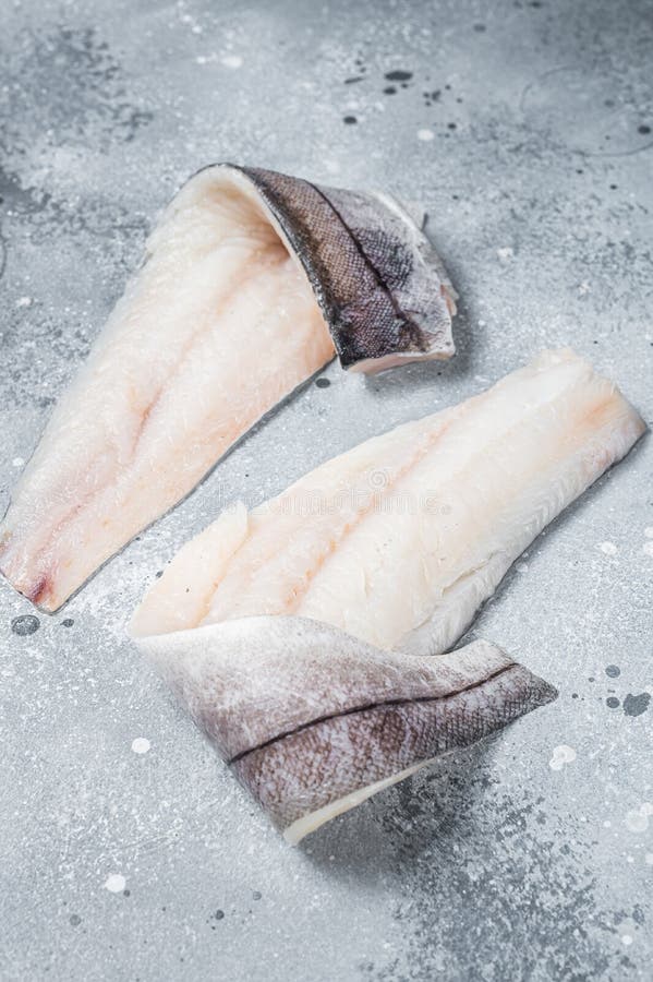 Two Raw Haddock Fish Fillets on Kitchen Table. Gray Background Stock ...