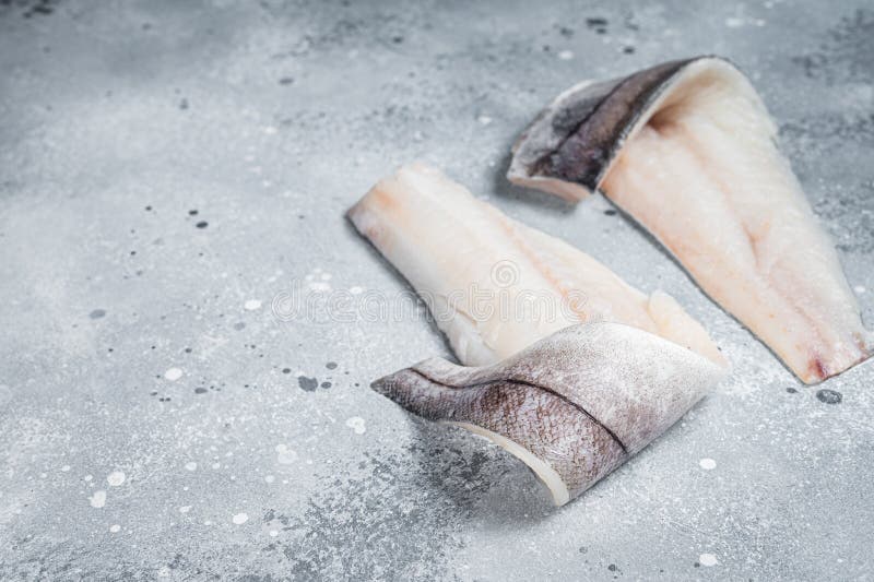 Two Raw Haddock Fish Fillets on Kitchen Table. Gray Background. Top ...