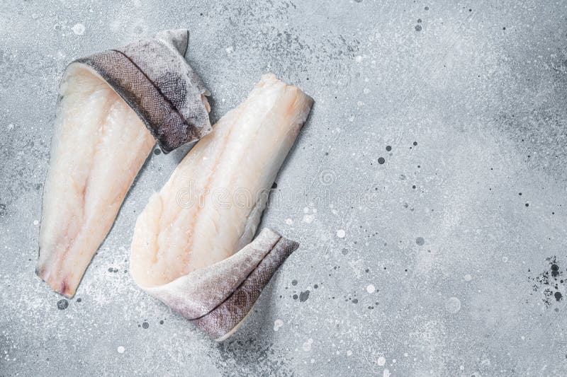 Two Raw Haddock Fish Fillets on Kitchen Table. Gray Background. Top ...