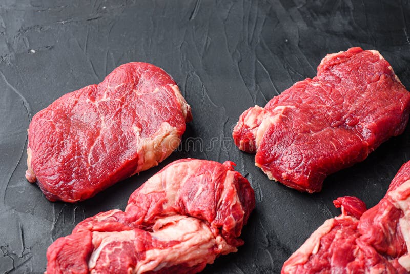 Two Raw Organic Rump Beef Steaks, Side View on Black Textured Table ...