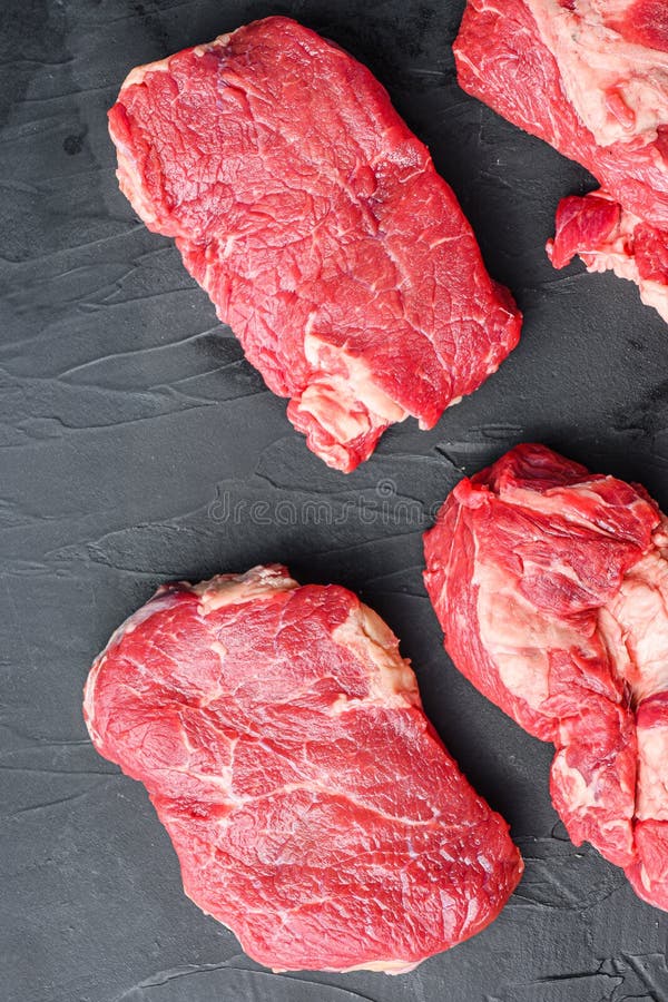 Two Raw Organic Rump Beef Steaks, Side View on Black Textured Table ...