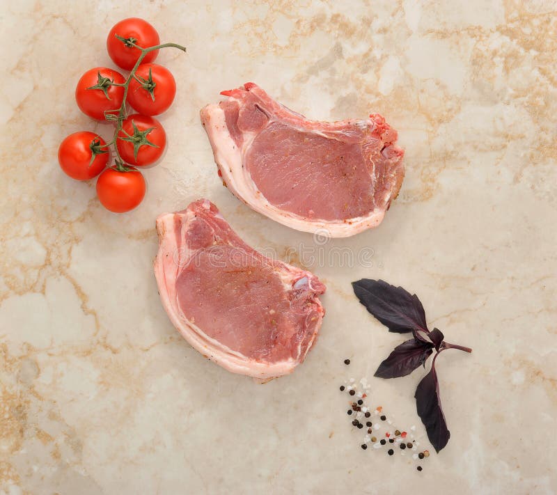 Two Raw Pork Chops on a Marble Table Stock Photo - Image of chop ...