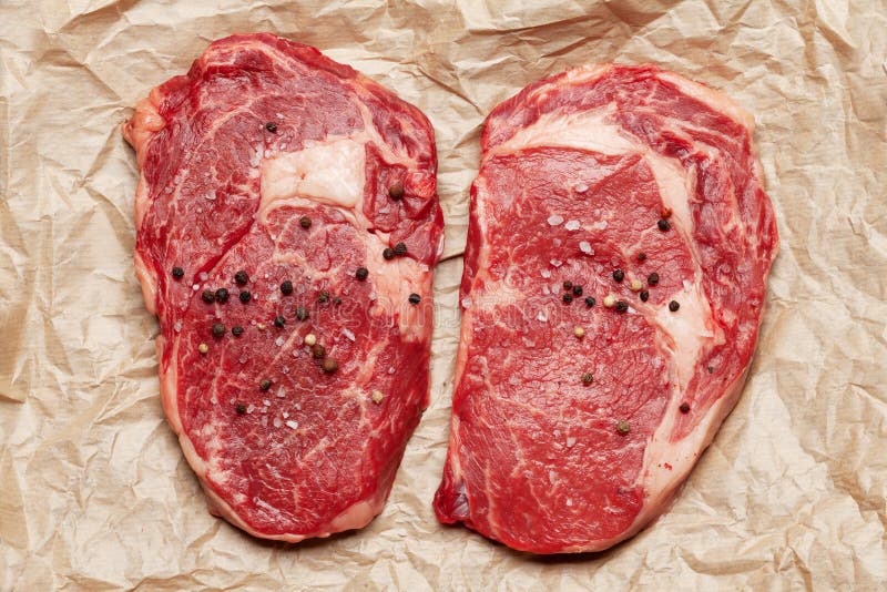 Two raw ribeye beef steaks stock photo. Image of beefsteak - 254208896