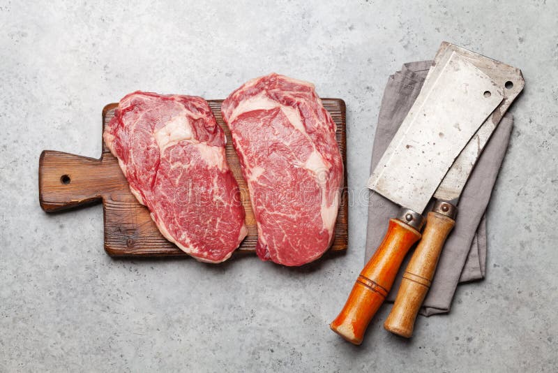 Two raw ribeye beef steaks stock photo. Image of butcher - 255259840
