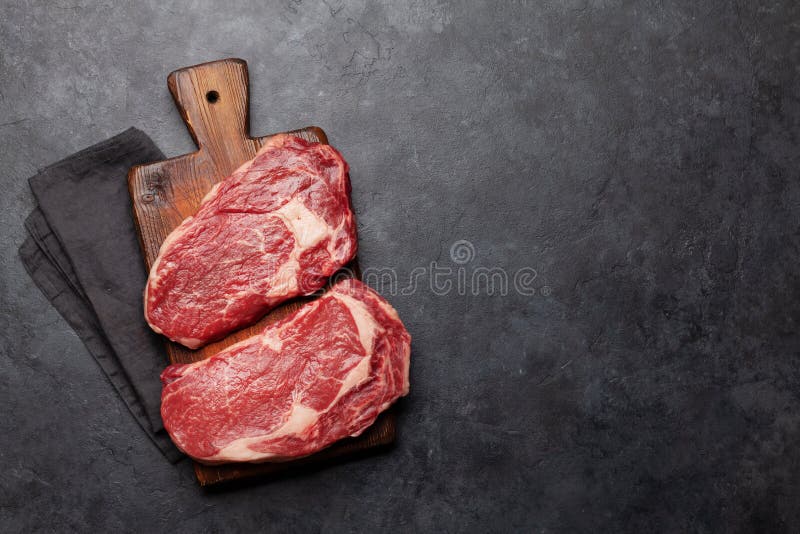 Two raw ribeye beef steaks stock photo. Image of prime - 264951072