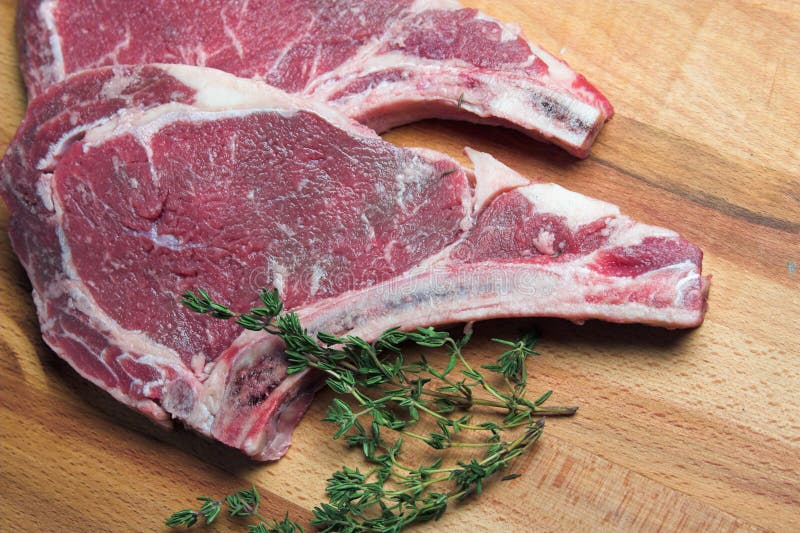 Two raw steaks stock photo. Image of fresh, herbs, bone - 21470816