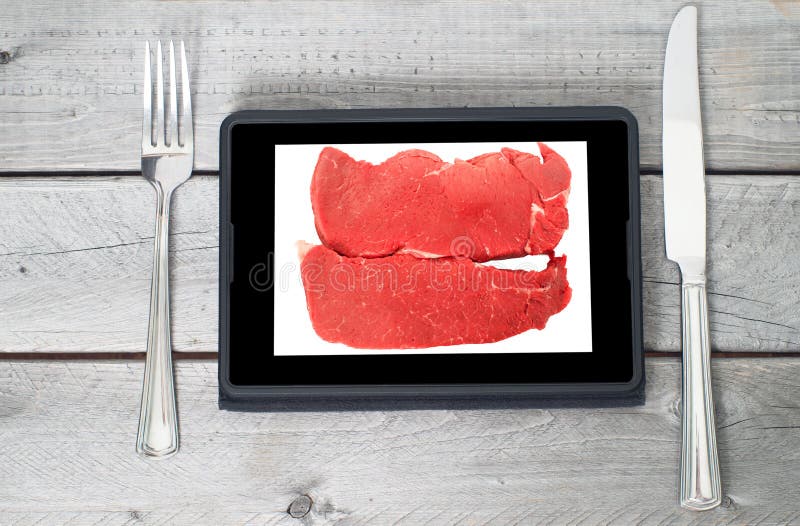 Two Raw Steaks on a Tablet Screen Stock Image - Image of steak, stack ...