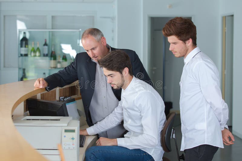 Two Receptionist Workers and Manager Standing at Hotel Counter Stock ...