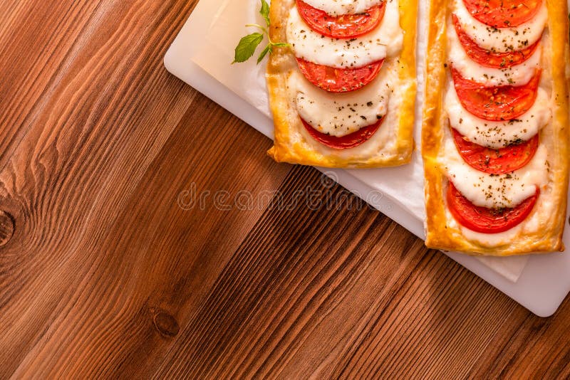 Two Rectangular Mini Pizzas with Tomatoes and Mozzarella on a Wooden ...