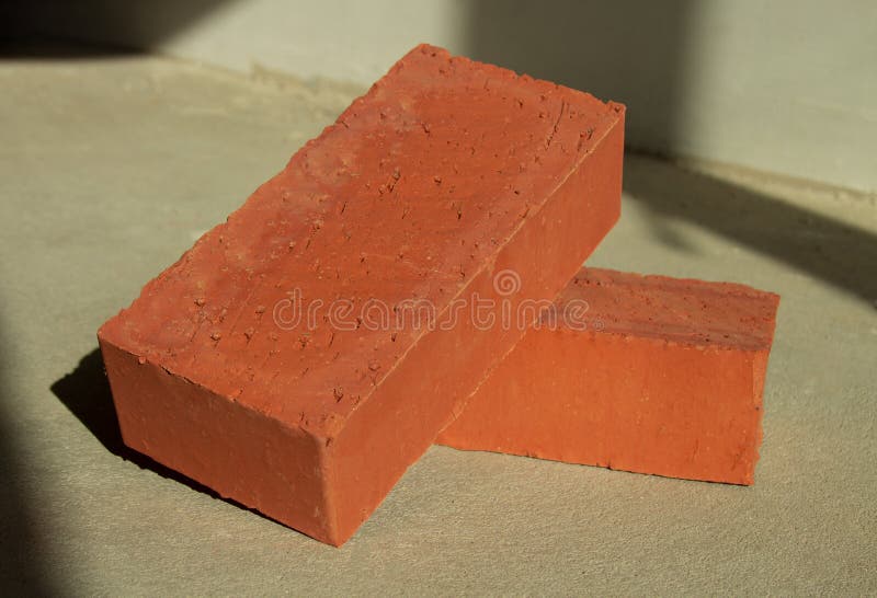 Two Red Bricks on a Concrete Floor in Sunlight Stock Photo - Image of ...