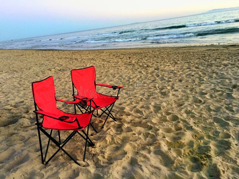 Two Red Chairs on the Beach Overlooking the Ocean Stock Photo - Image ...