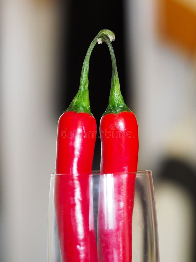 Two Red Chili Peppers in a Glass Stock Image - Image of closeup ...