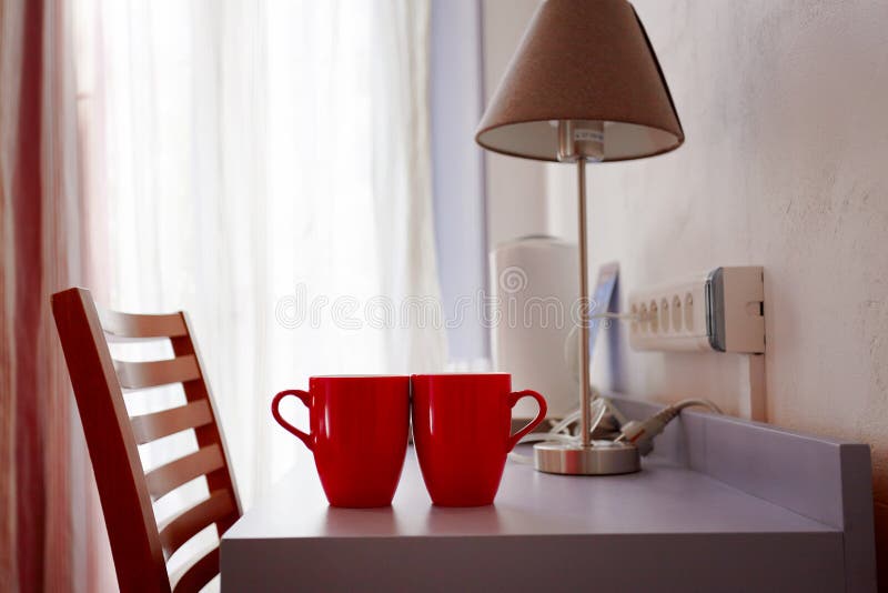 Two Red Coffee Cups are on the Work Table in the Room Stock Photo ...