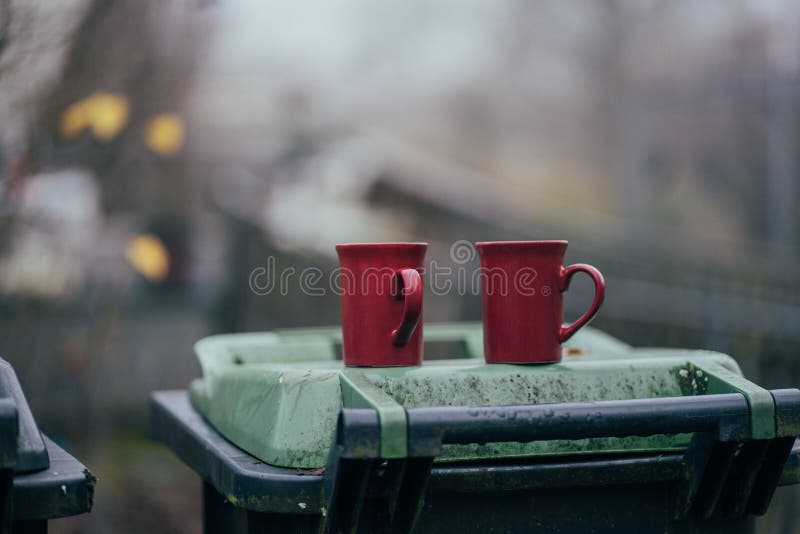 Two Red Cups on the Big Green Garbage Container Stock Photo - Image of ...