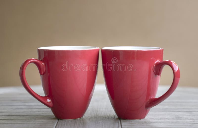 Two red cups on table stock photo. Image of twin, wood - 196164402