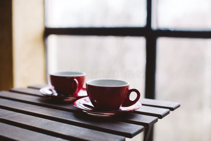 Two red cups on table stock image. Image of cups, kitchen - 69741609