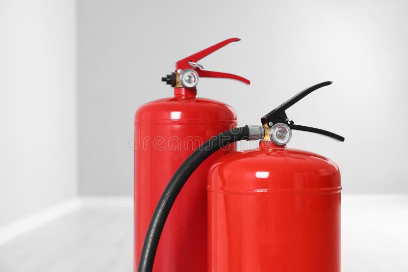 Two Red Fire Extinguishers Indoors, Closeup View Stock Image - Image of ...