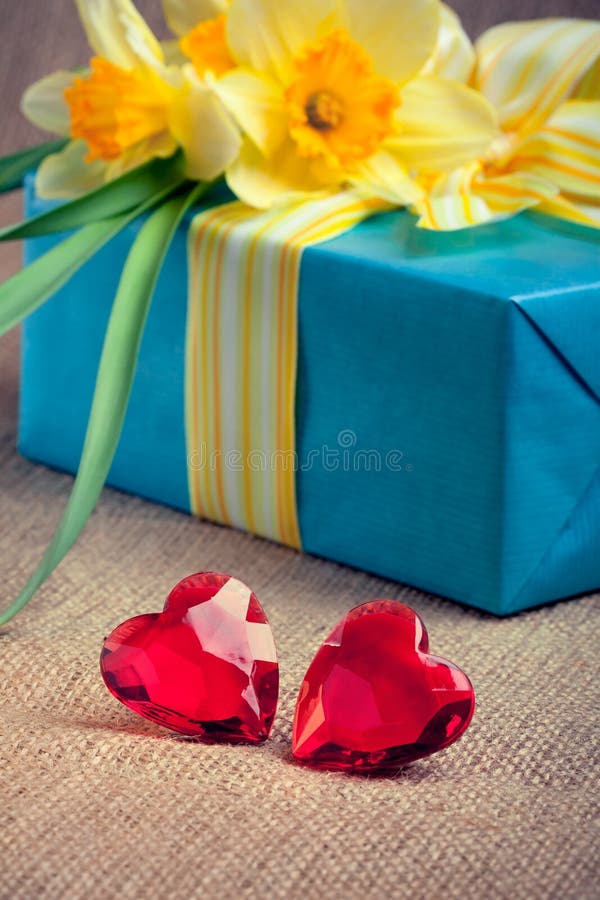 Two Red Glass Hearts with a Gift Box and Flowers Stock Image - Image of ...