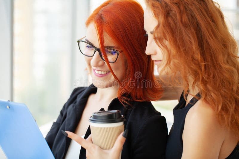 Two Red-haired Woman Work Together in the Modern Office Stock Image ...
