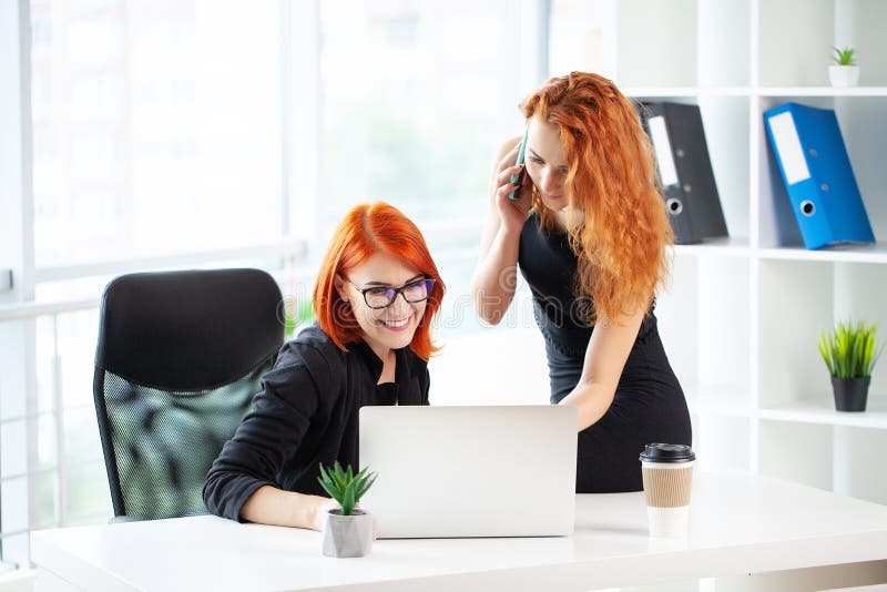 Two Red-haired Woman Work Together in the Modern Office Stock Photo ...