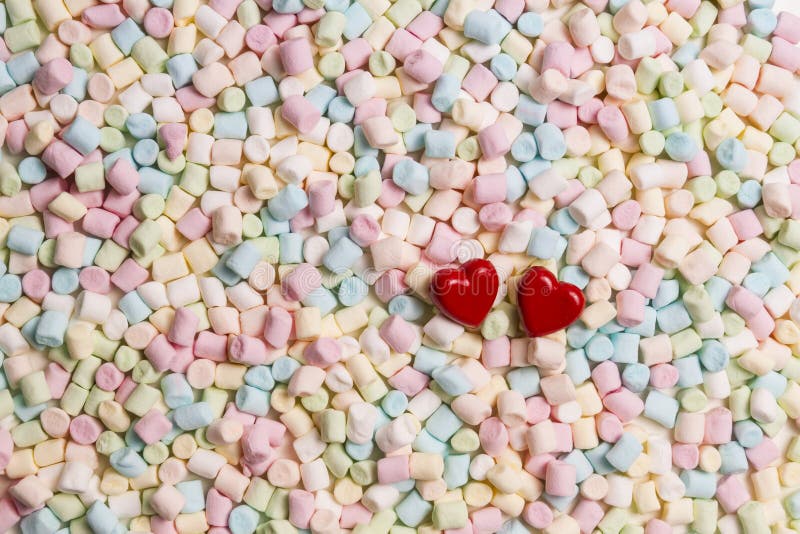 Two Red Hearts on Colorful Mini Marshmallows Background Stock Photo ...