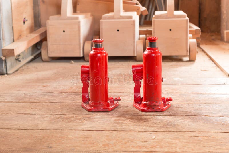 Two Red Hydraulic Car Jack on Wooden Stock Photo - Image of housework ...