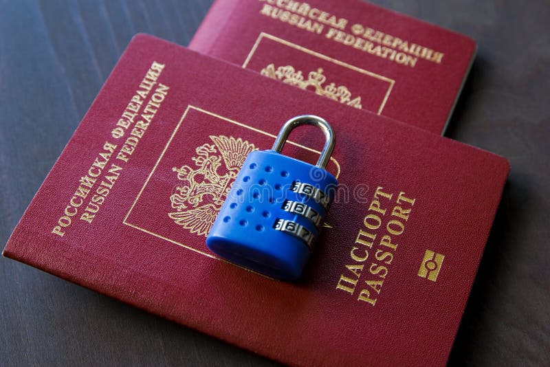 Two Red Passports with a Blue Lock on a Wood Background Stock Image ...