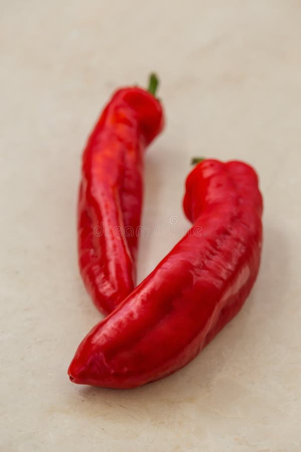 Two Red Peppers on Marble Tabletop Stock Image - Image of green ...