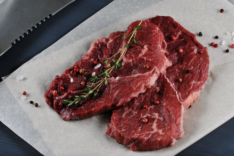 Two Red Raw Beef Steak on Paper with Spices Top View Stock Photo ...