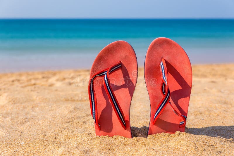 Two Red Slippers Upright in Sand of Beach Stock Photo - Image of beach ...